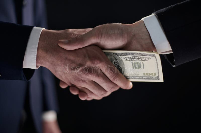 Handshake with the Transfer of Money on a Black Background Stock Image ...