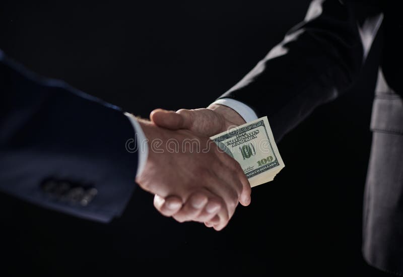 Handshake with the Transfer of Money on a Black Background Stock Image ...
