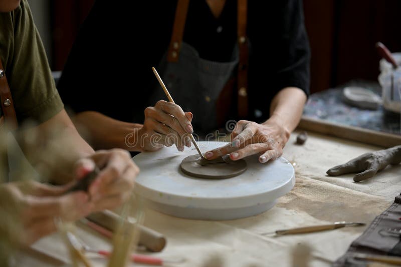 Close-up Image of a Male Pottery Artist Holding a Stick, Making ...
