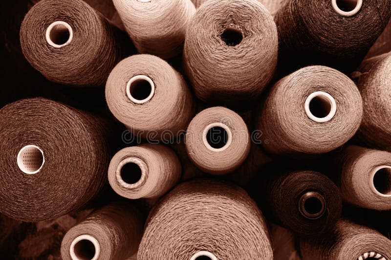 Close-up Image Showcasing Multiple Yarn Spools in an Array of Earthy ...