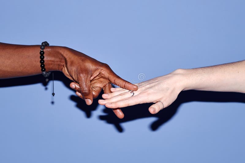 Interracial Hands Touching with Soft Blue Background Stock Image ...