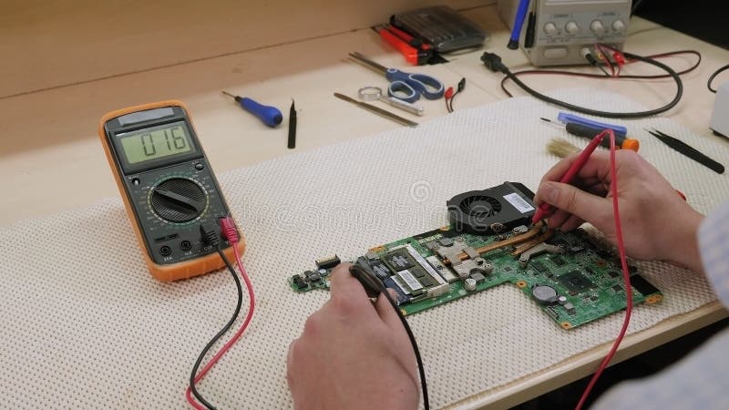 A Technician Man Hand Measuring Electrical Voltage of Computer ...