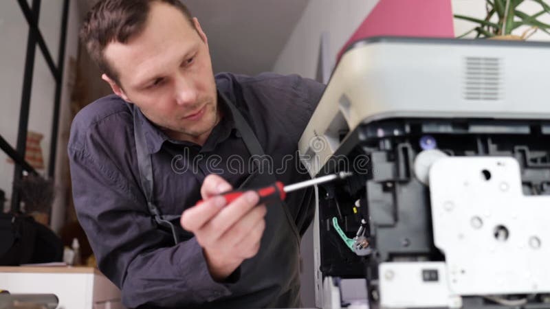 Printer Repair Technician. a Male Handyman Inspects a Printer before ...