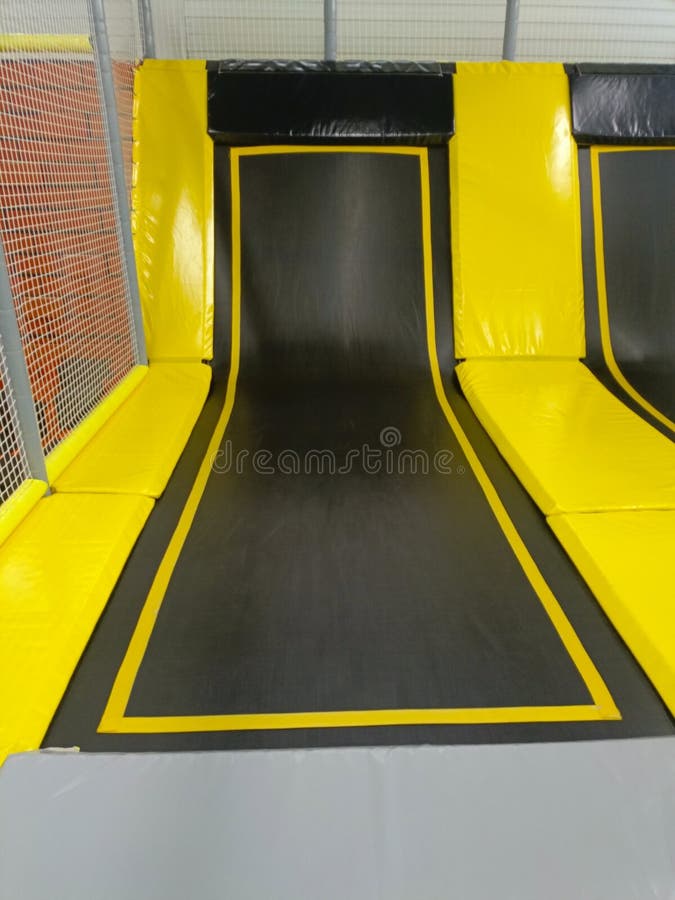 Close-Up of Indoor Trampoline with Safety Padding in Brightly Lit Play ...