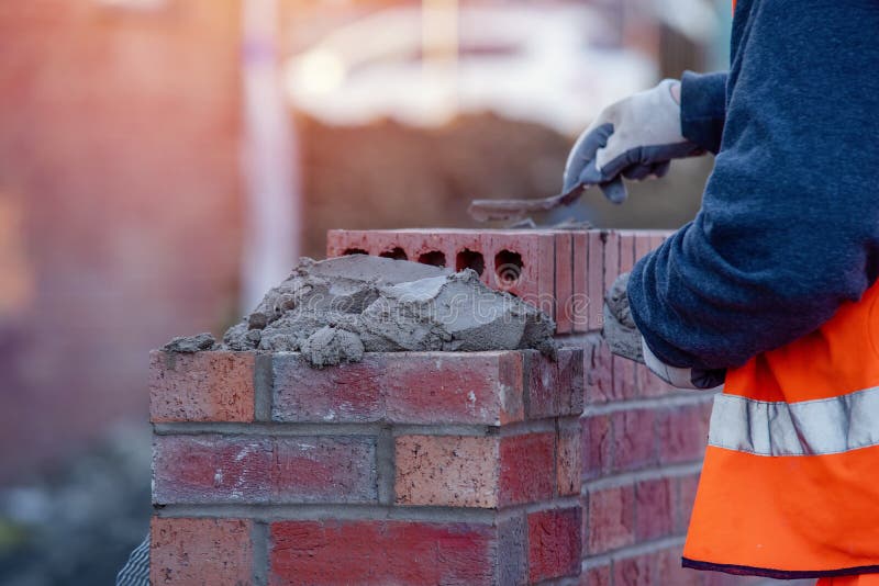 Close Up of Industrial Bricklayer Laying Bricks on Cement Mix on ...