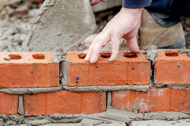 Close Up of Industrial Bricklayer Laying Bricks on Cement Mix on ...