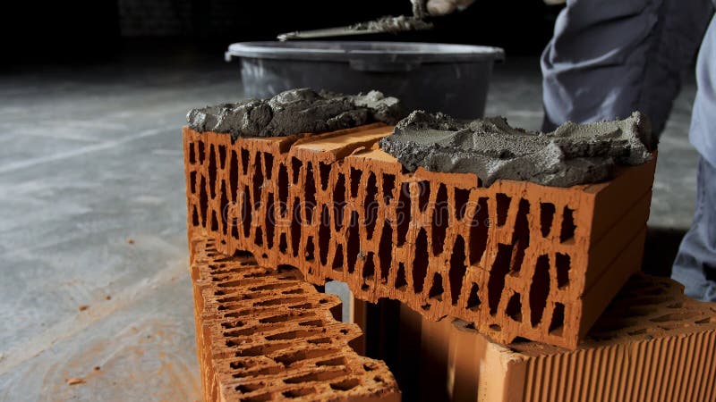 Close Up of an Industrial Worker Putting Cement on the Brick for ...