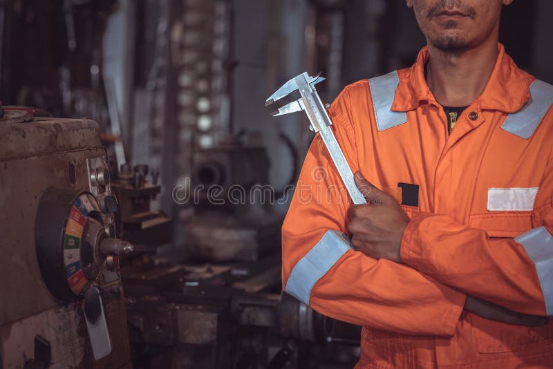 Close-up Industrial Workers, Wearing Safety Clothing, Using Vernier ...