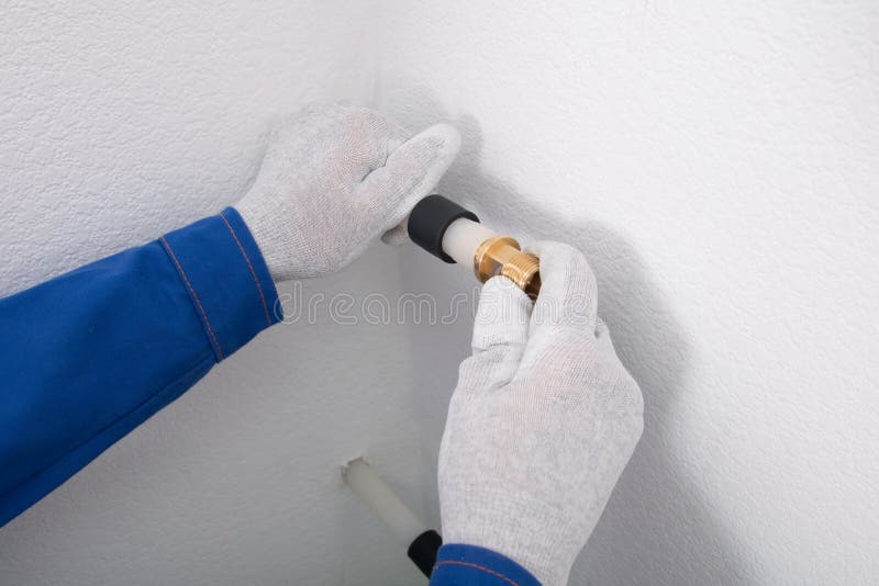 Close-up, Installation in a Plastic Pipe of a Copper Tip with a Thread ...