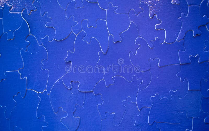 Close-Up of Interlocking Puzzle Pieces with Blue Background Stock Photo ...