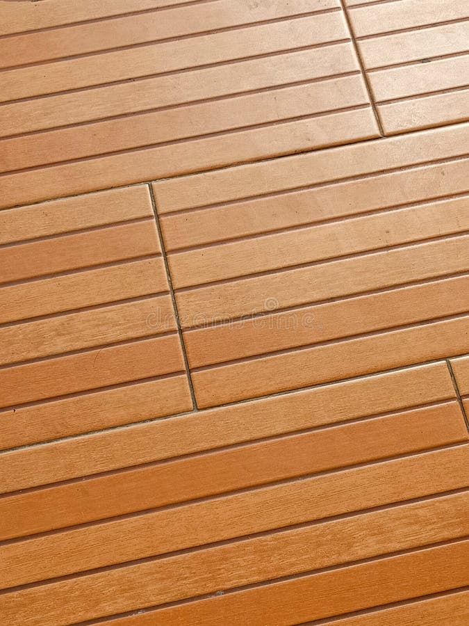 A Close-up of Interlocking Wooden Decking Tiles with a Modern ...