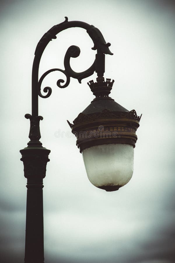 Close-up of an Iron Lamp Post with a Lit Light Bulb. Stock Photo ...