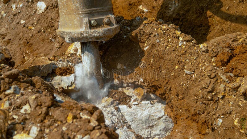 CLOSE UP: Jackhammer Creates a Cloud of Dust As it Strikes Against ...