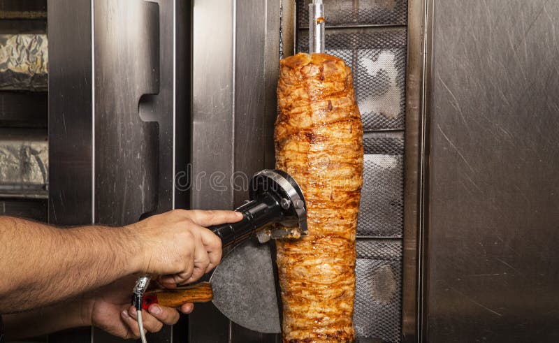 Close-up of Kebab and a Hand Slices the Meat with Slicer Stock Photo ...