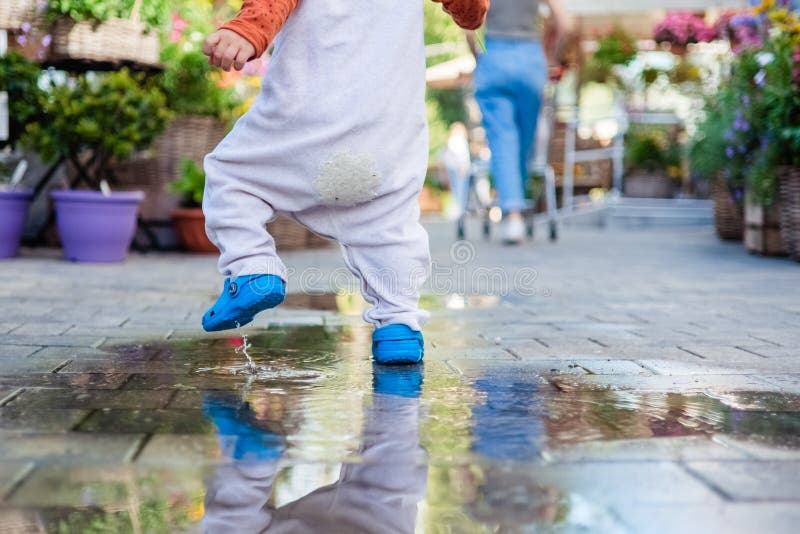 Close Up of Kids Feet in Puddle. Reflection in Water Stock Image ...