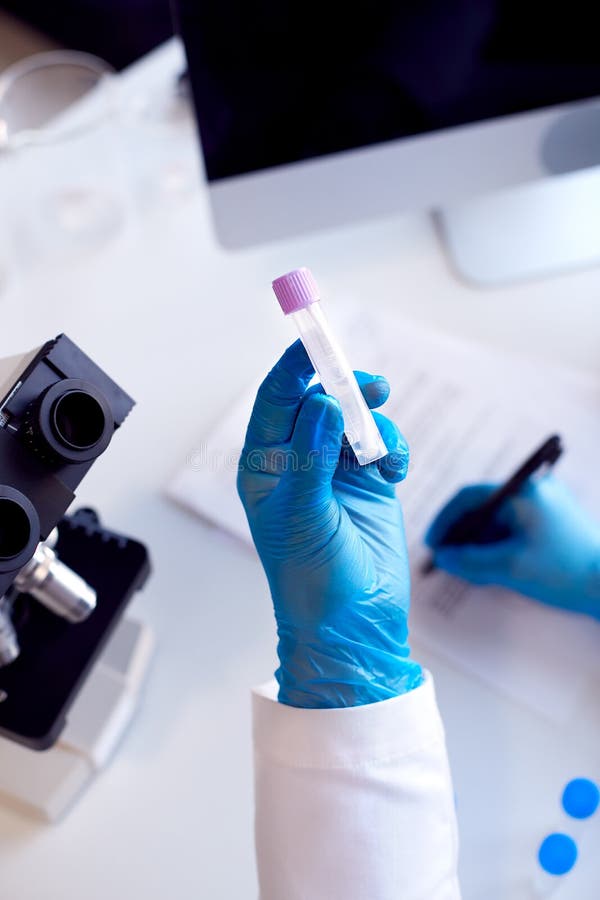 Close Up of Lab Worker Conducting Research Using Microscope Holding ...