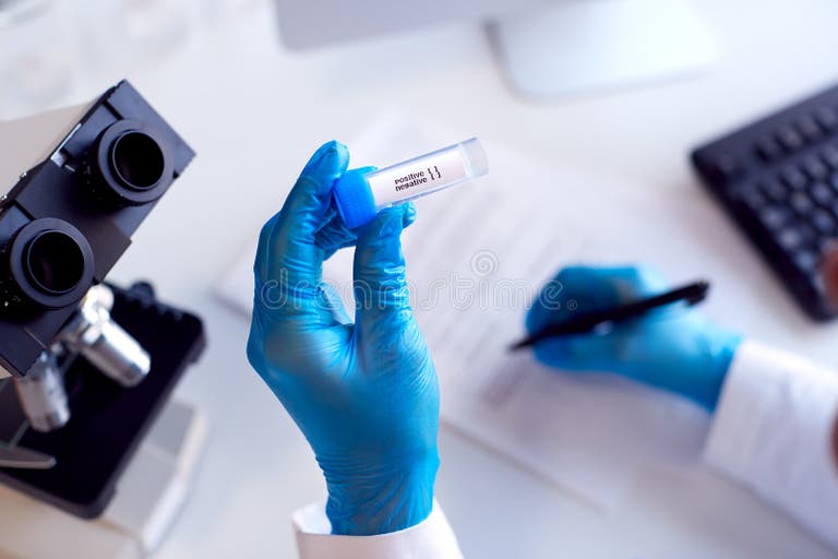 Close Up of Lab Worker Doing Test Using Microscope Holding Test Tube ...