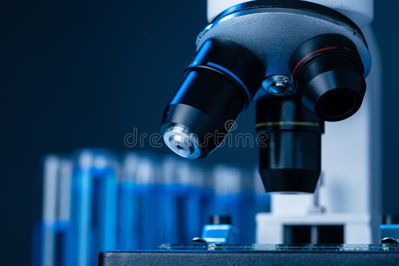 Close Up of Laboratory Microscope with Set of Test Tubes with Blue ...