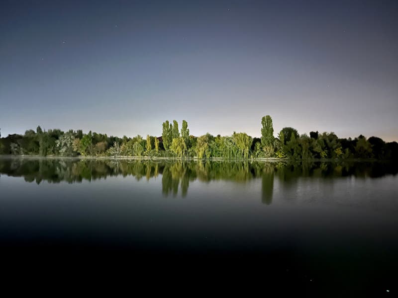 Closeup of Lake in Which the Moonlit Trees are Reflected Stock Photo ...