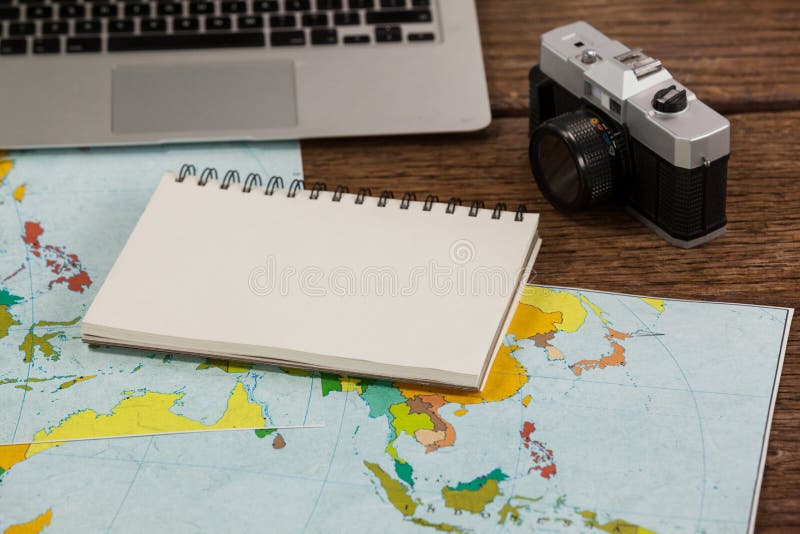 Close-up of Laptop, Camera, Notepad and Maps Stock Image - Image of ...