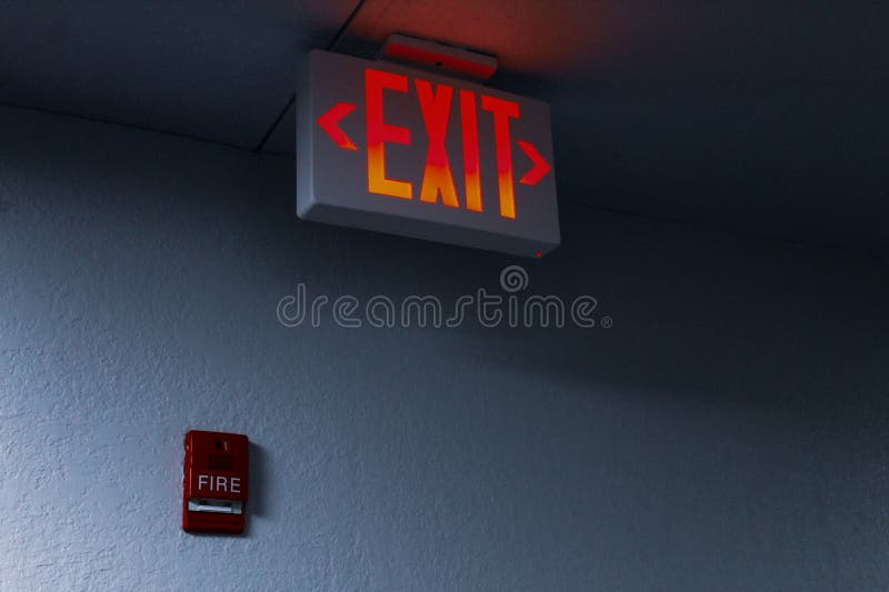 Close-up of a Large Illuminated LED Emergency Exit Sign and Fire Alarm ...