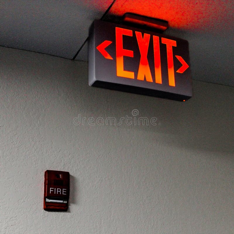 Close-up of a Large Illuminated LED Emergency Exit Sign and Fire Alarm ...