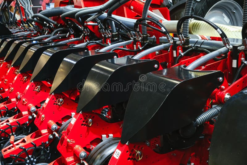 Grain Seeder Attached To a Tractor Sows Grain in the Field. Grain ...