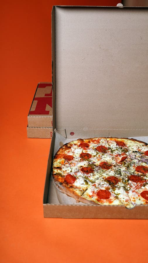 Close Up of Large Pizza in Box on Orange Background. Appetizing Pizza ...
