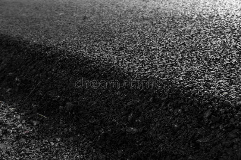 Close-up on a Layer of New Asphalt at the Road Under Construction ...