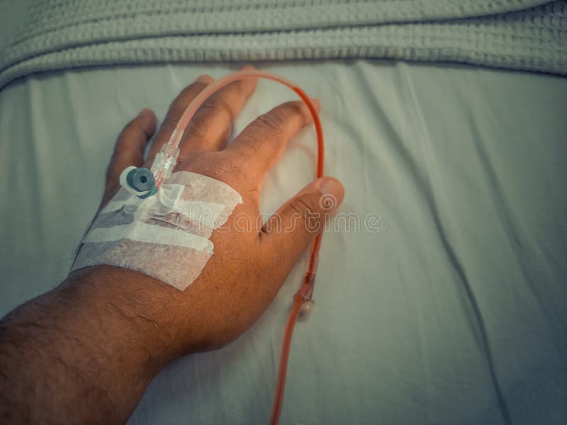 Close Up of Left Hand of an Unidentified Man with Green Branula ...