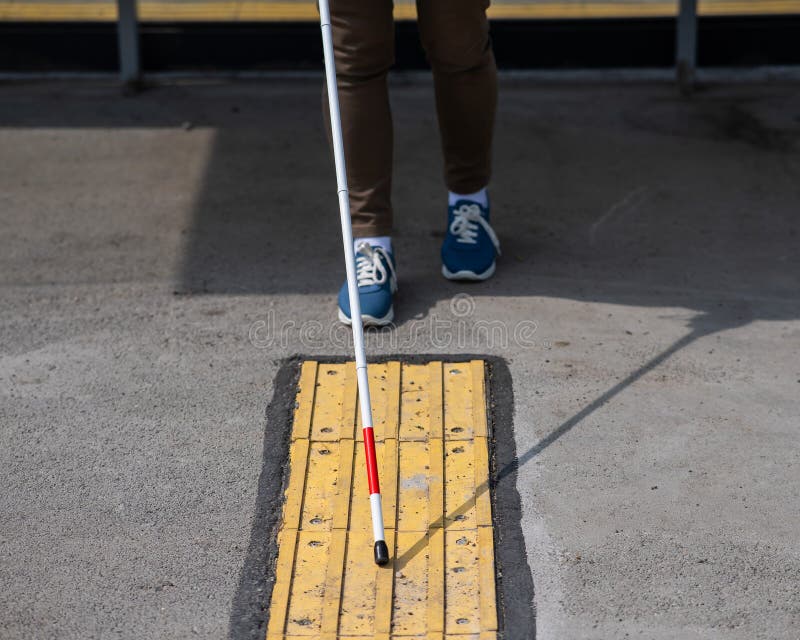 Close-up of the Legs of a Blind Woman at a Bus Stop. Stock Photo ...