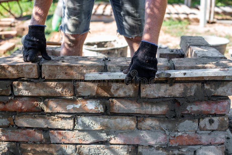 Close-up of Leveling Bricks during Construction of Brick Structure ...