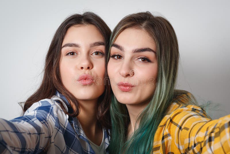 Close Up Lifestyle Selfie Portrait Of Two Young Positive Woman Having