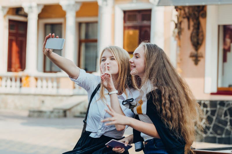 Close Up Lifestyle Selfie Portrait Of Two Young Positive Woman Having