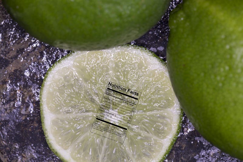Close Up on Slice of Lime with Fresh Limes with Nutrition Label Stock ...