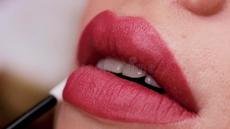 Close-up of the Lips of a Model with a Permanent Make-up of Red Lips on ...