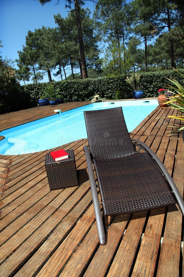 Close-up of Long Chair by the Swimming Pool Stock Photo - Image of ...