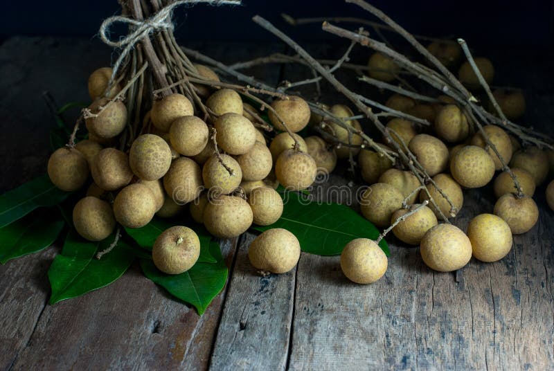 Close Up of Longan Fruit with Leaves is Placed on a Rustic Wooden Floor ...