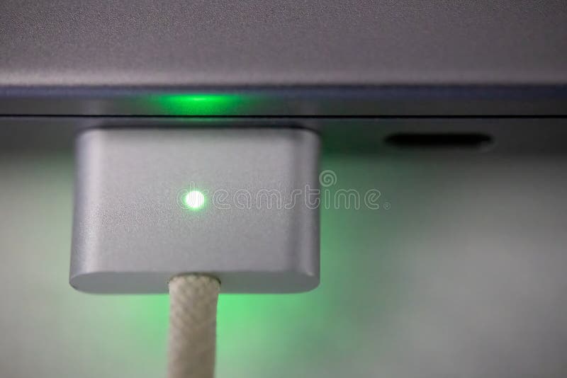 Close Up MacBook Computer Charging during the Night Side View. MagSafe ...