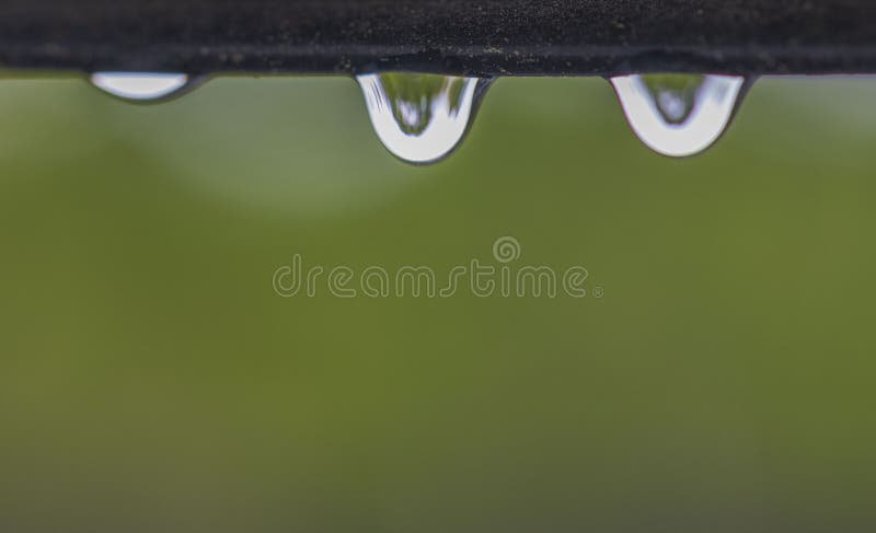 Close Up Macro View of Falling Raindrops from Window Frame of Skylight ...