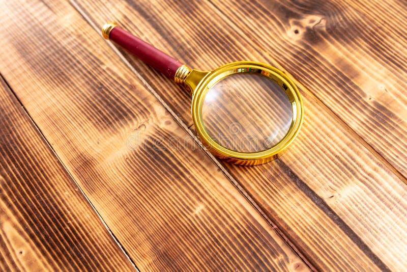 Close-up of a Magnifier on a Wooden Background Stock Image - Image of ...