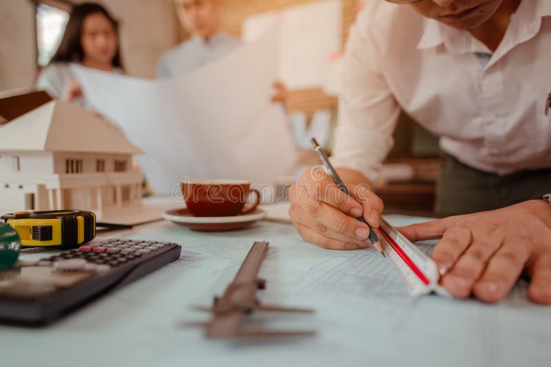 Close Up of Male Architect Hands Writing Model on the Desk. Blurred ...