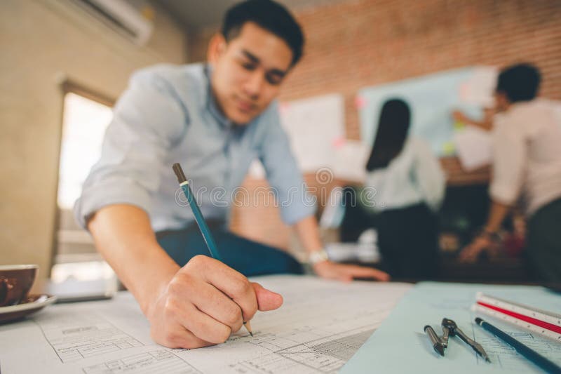 Close Up of Male Architect Hands Writing Model on the Desk. Blurred ...