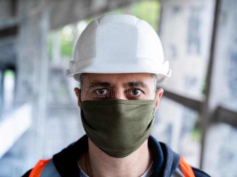 Portrait of a Male Builder in a Construction Helmet and a Medical ...