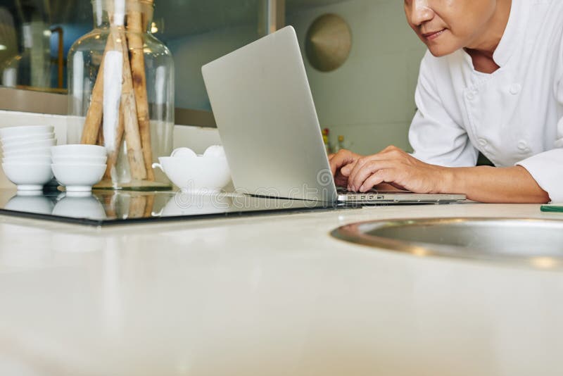 Cook using laptop stock photo. Image of looking, occupation - 158743072