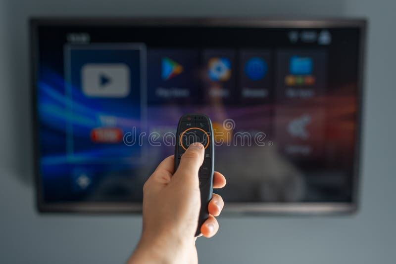 Close-up of Male Hand Using Remote of Modern Smart Tv on Background of ...