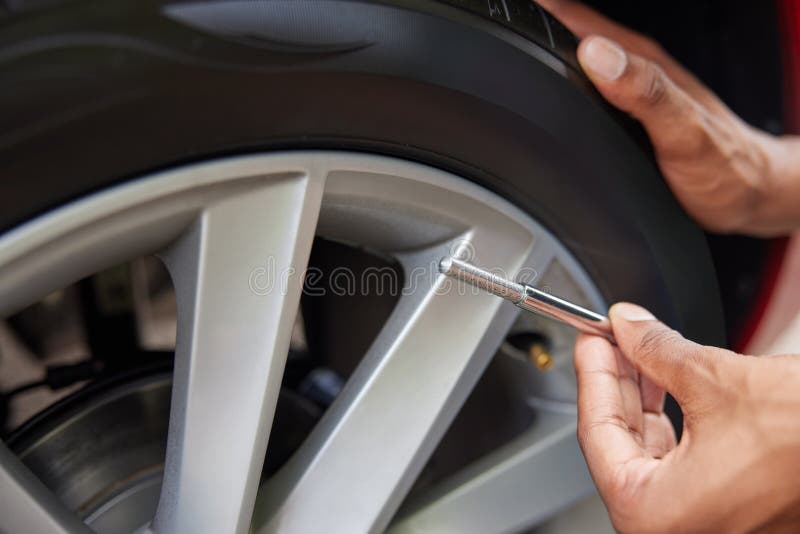 Close-Up of Man Checking Car Tyre Pressure with Gauge Stock Image ...