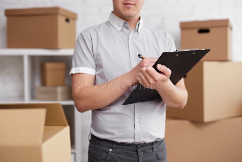 Close Up of Man Checking Something in Clipboard in Warehouse Stock ...