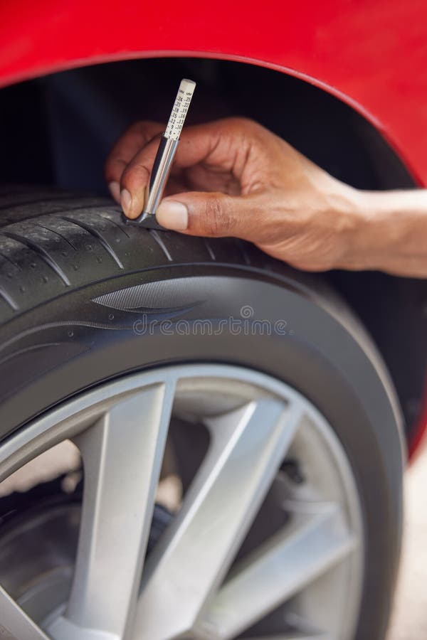 Close-Up of Man Checking Tread on Car Tyre with Gauge Stock Photo ...