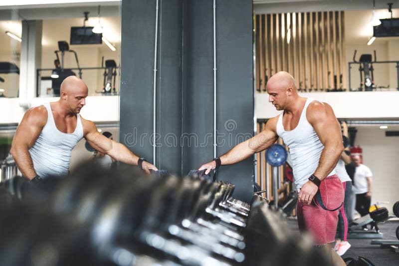 Close Up of Man Choosing Dumbbell from Rack. Routine Workout for ...